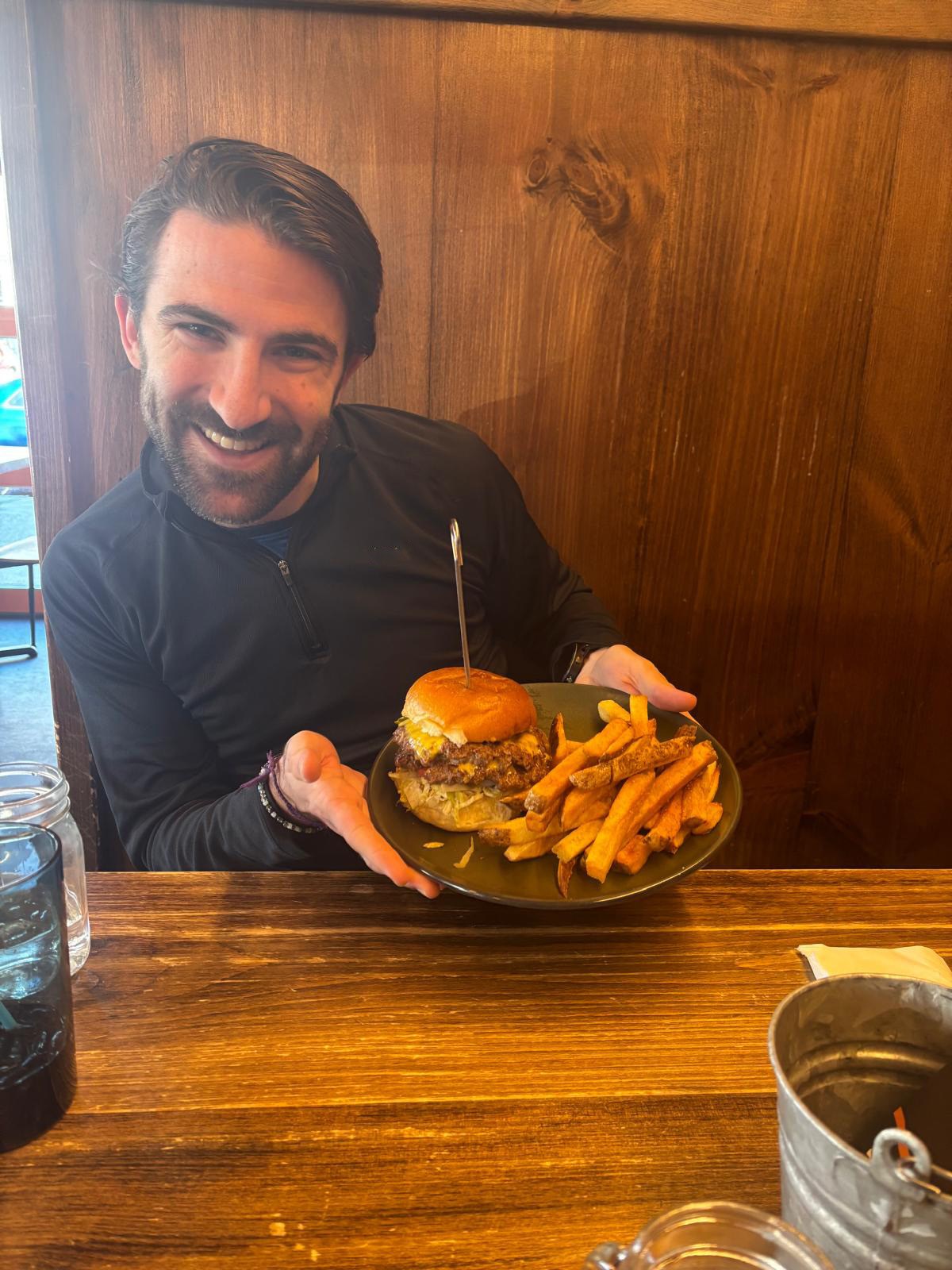 Michael enjoying a burger and fries